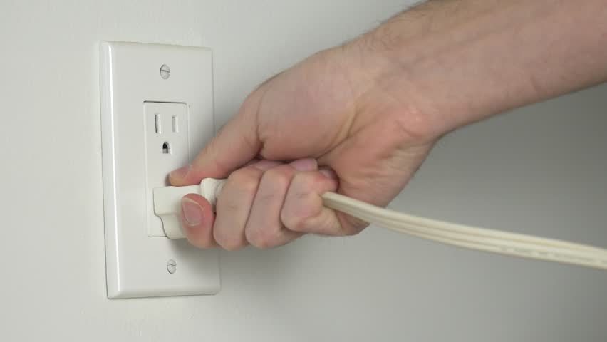 Close-up Shot Of A Man Plugging And Unplugging An Orange Electrical ...