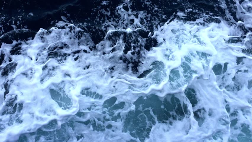 Aerial Drone Footage Of Textured Pattern Formed By White Sea Foam ...