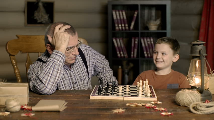 Impatient Boy Strewing Chess Pieces Around Unwilling To Continue Game ...