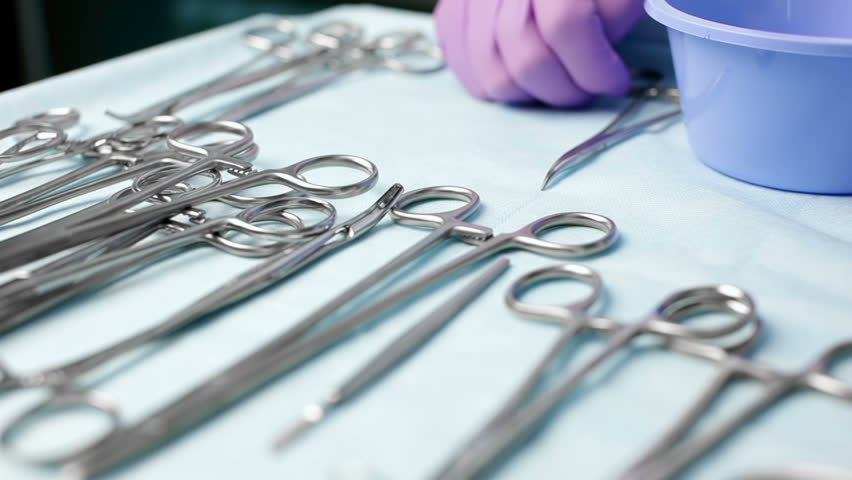 Preparation Of Surgical Instruments. Doctor Rubs Clip Before Surgery ...
