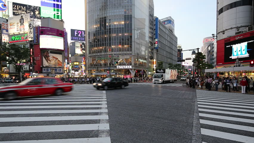 TOKYO, JAPAN - MAY 15: People And Cars Cross The Famous Scramble ...
