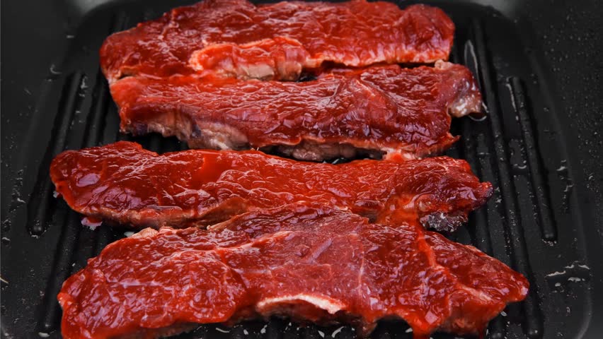 Fresh Raw Bloody Beef Steaks On Black Grill Plate Stock Footage Video ...
