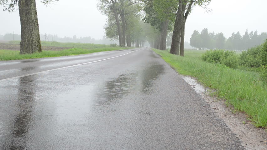 Closeup Of Water Rain Drops Fall On Rural Asphalt Road Between Old ...