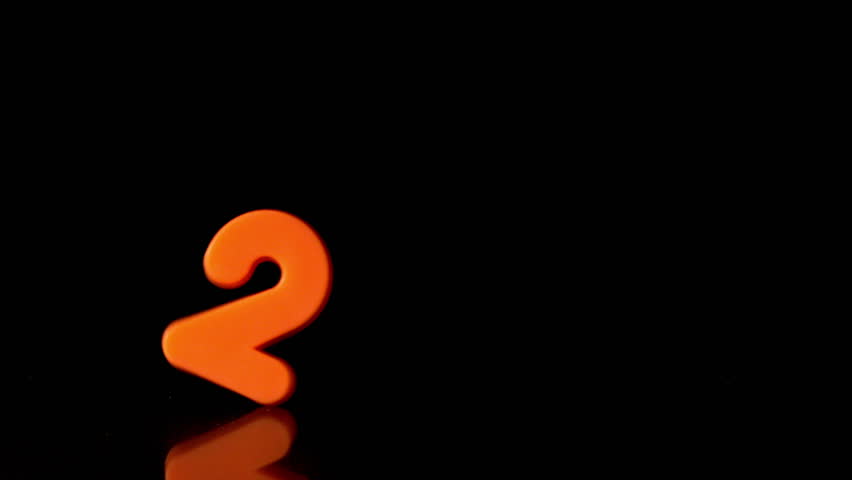 Orange Number Two Falling On Black Background In Slow Motion Stock ...